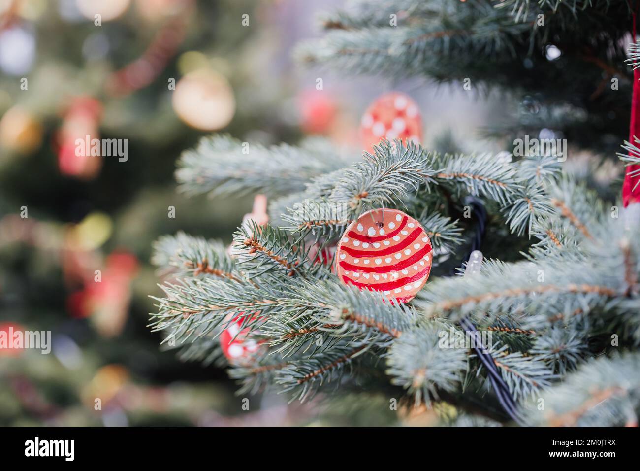 Handmade clay decoration on a Christmas tree outdoor. Diy creative ...