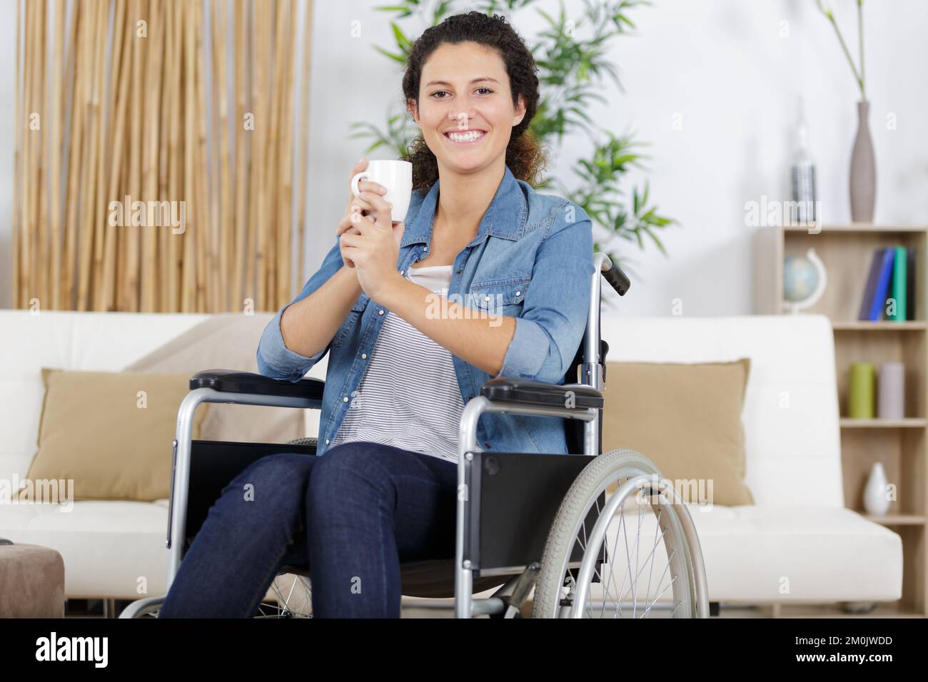 disabled woman in wheelchair having a drink Stock Photo - Alamy