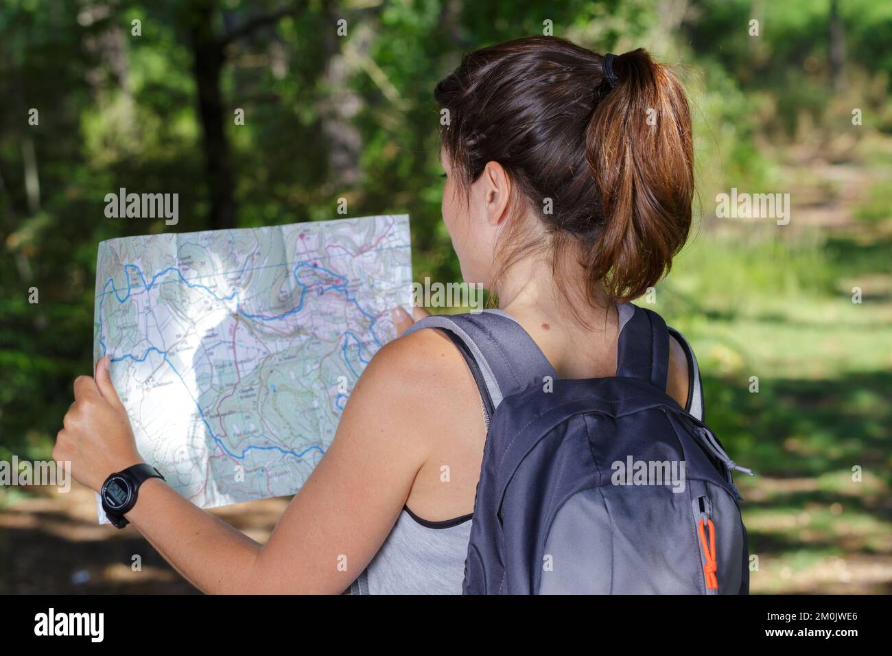 women hikers looking at map Stock Photo - Alamy