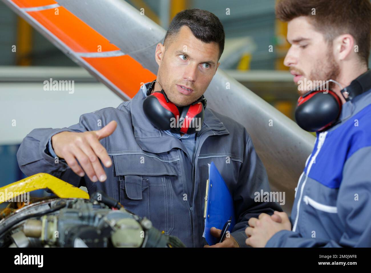 aviation security team talking next to airplane Stock Photo - Alamy