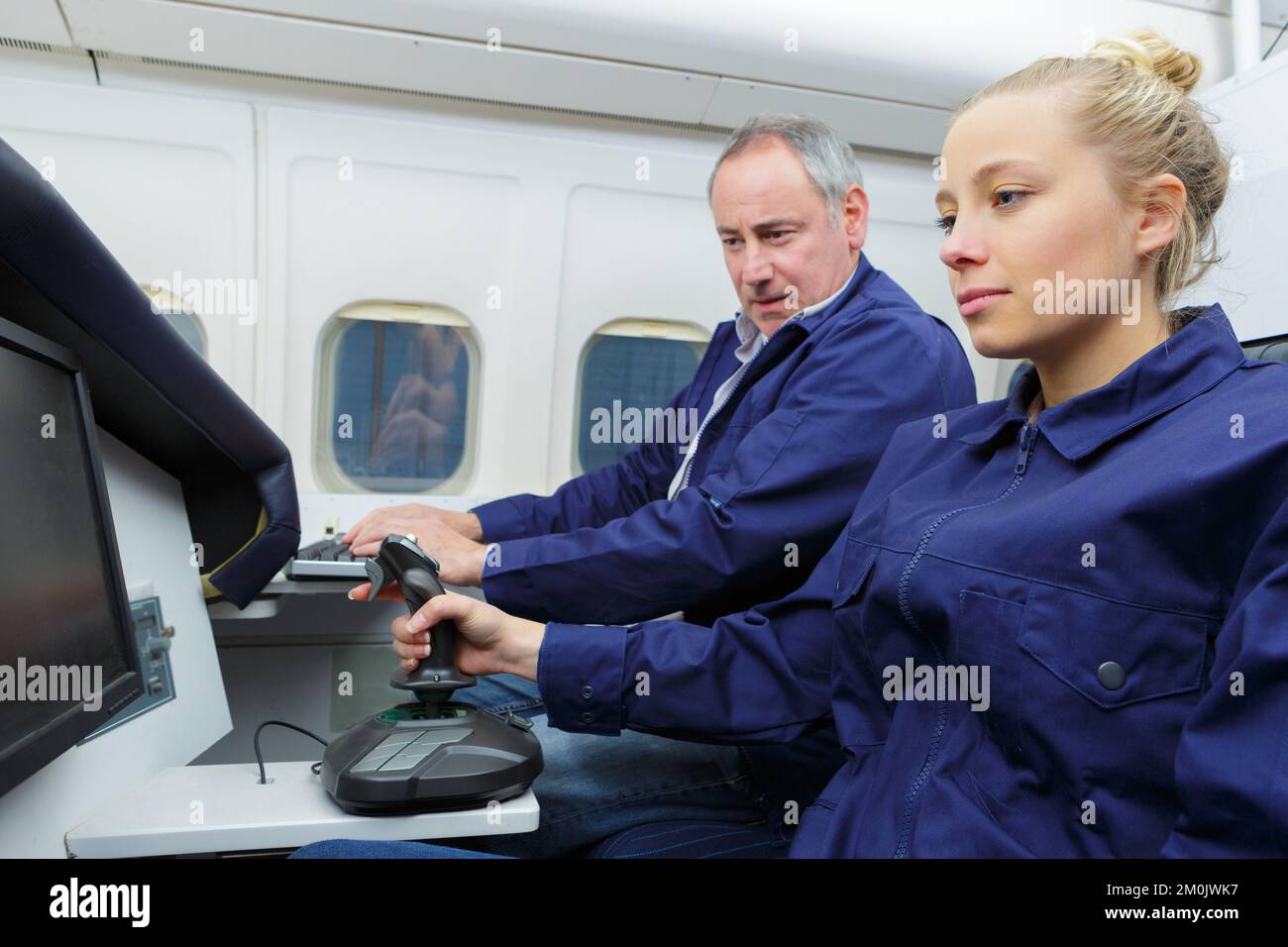 beautiful blonde woman using a pilot simulator Stock Photo - Alamy
