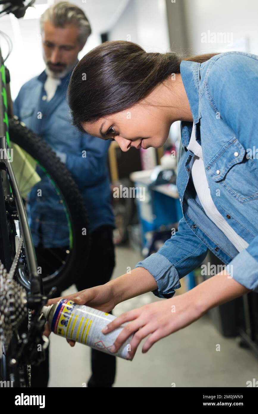 portrait of couple putting brake fluid Stock Photo - Alamy