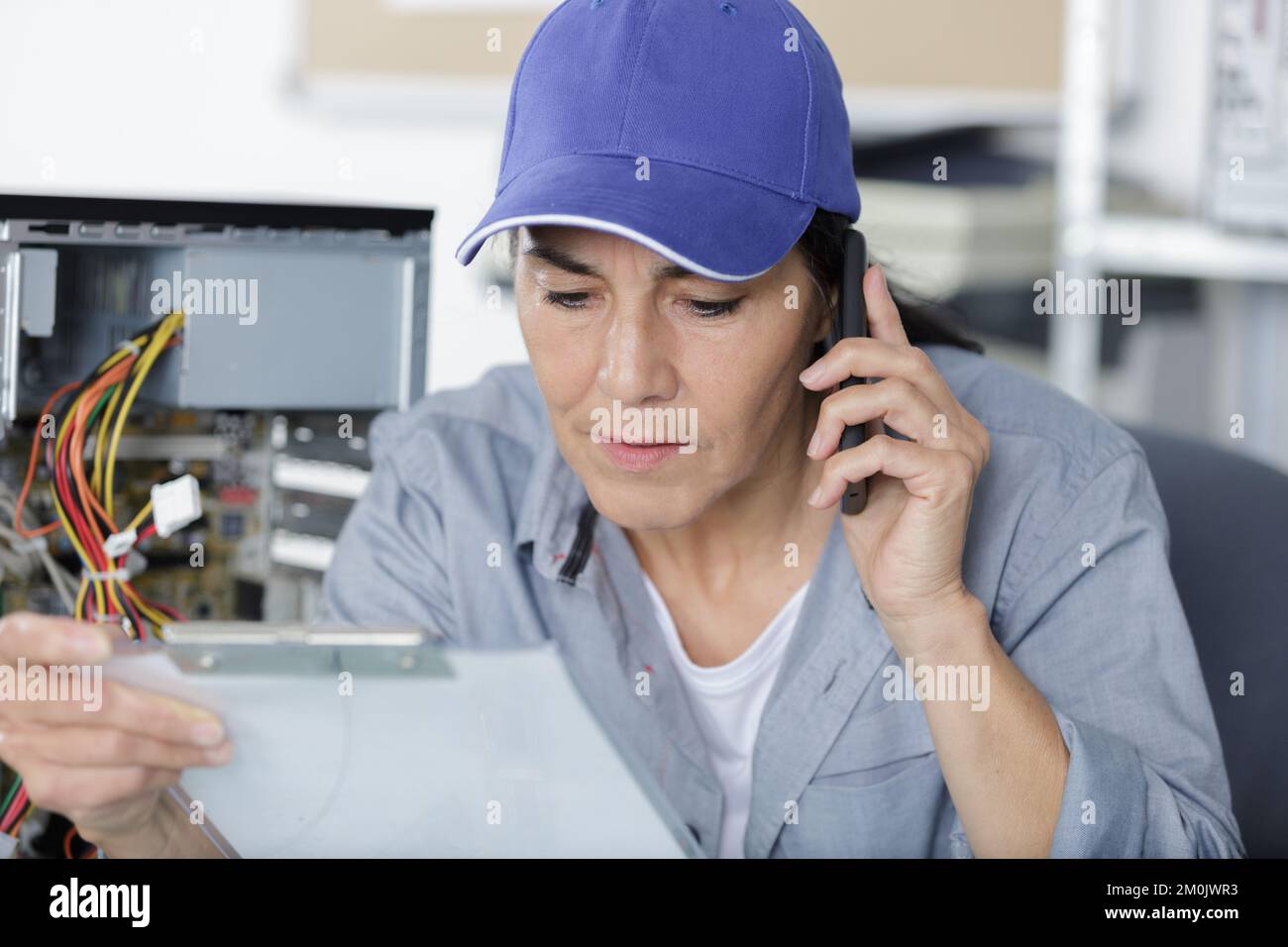 mature woman fixing a computer Stock Photo - Alamy