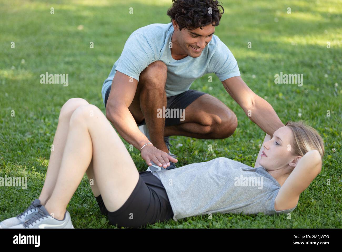 Sportsman sportswoman doing stretching exercise hi-res stock ...