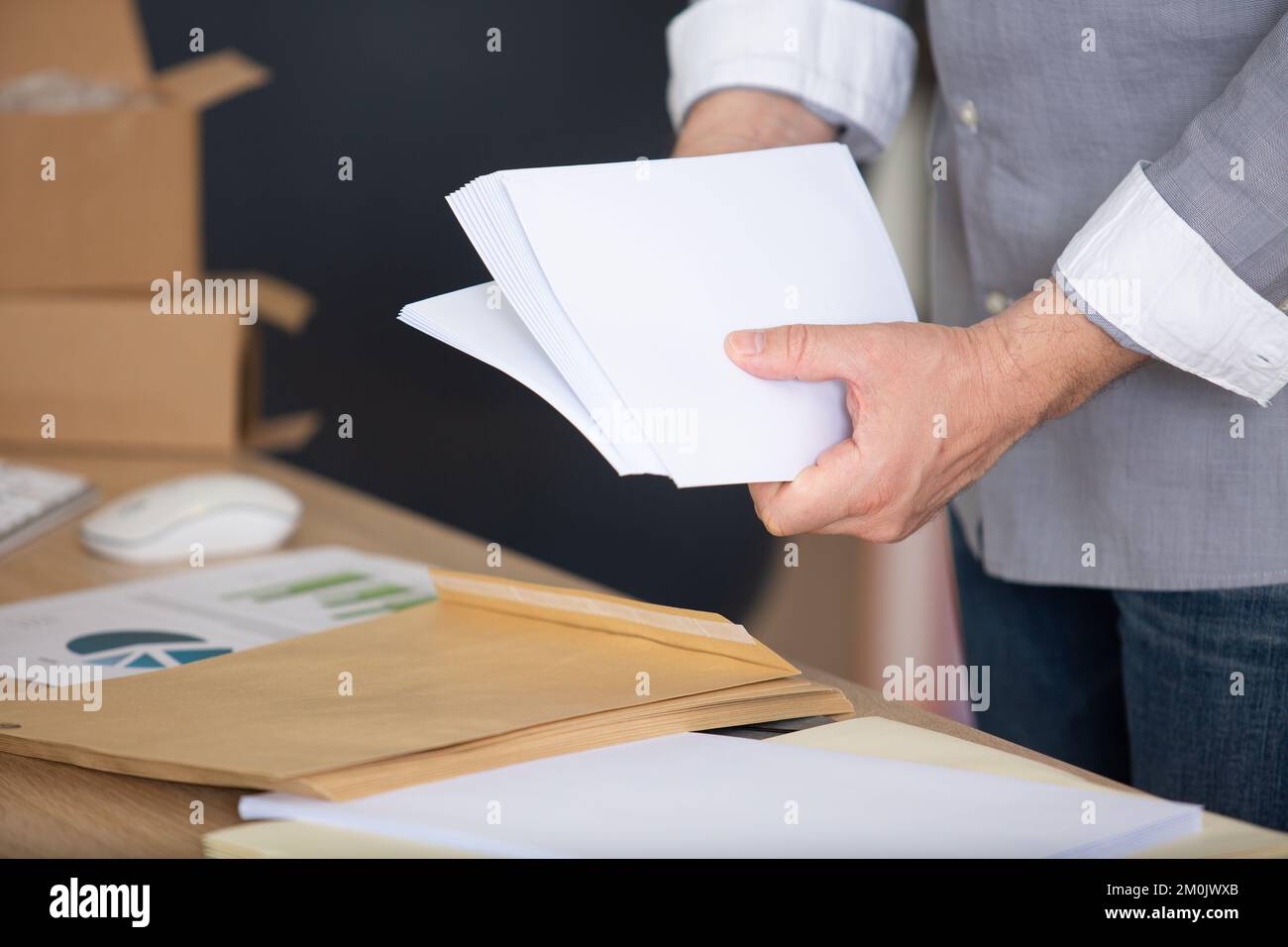 hand holding envelopes on white background Stock Photo - Alamy