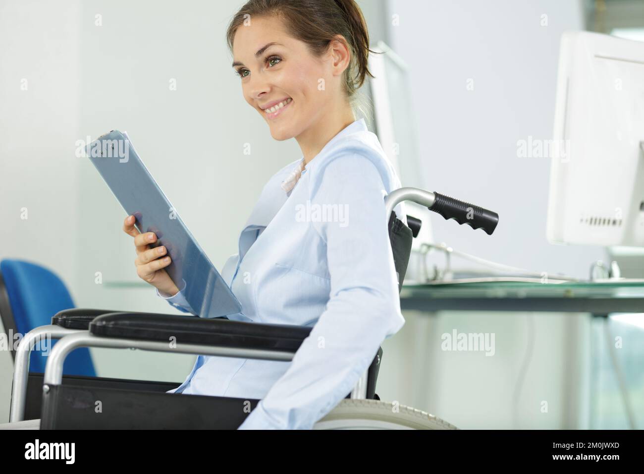 beautiful female office worker in wheelchair Stock Photo - Alamy
