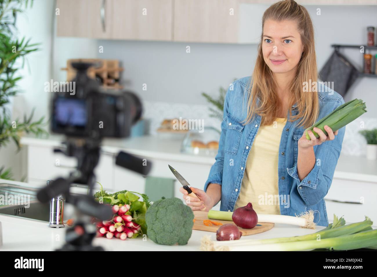 young woman filming cooking tutorial at home Stock Photo - Alamy