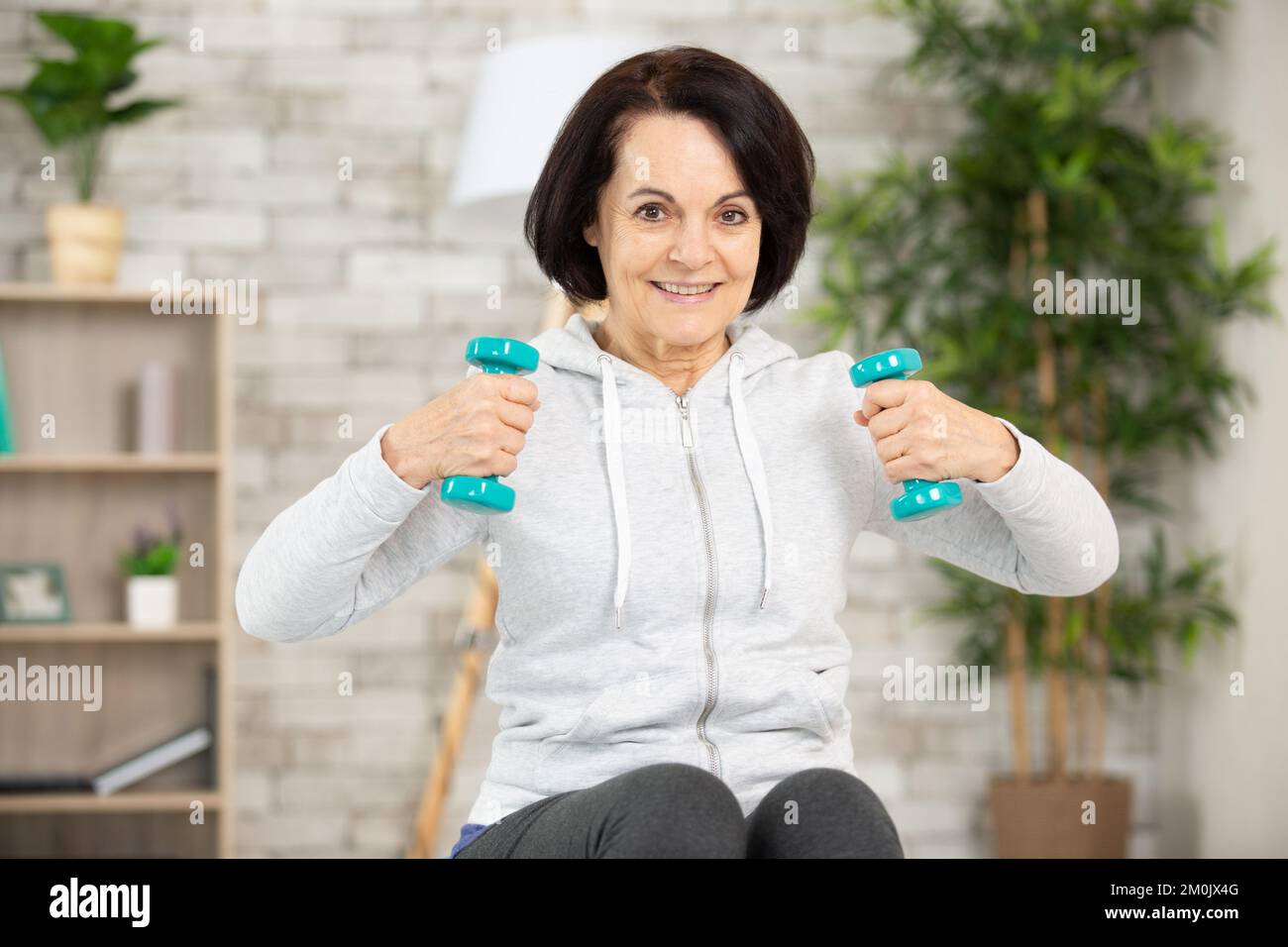 senior woman doing fitness exercices with weights Stock Photo - Alamy