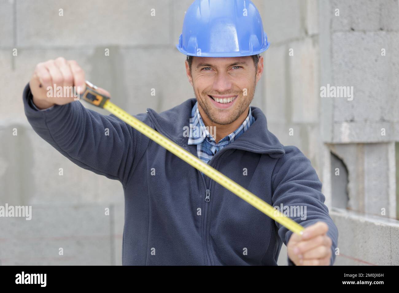 man with tape measure outdoors Stock Photo - Alamy