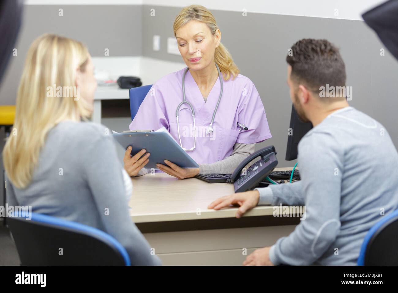 obstetrics and gynecology talking to a couple Stock Photo - Alamy