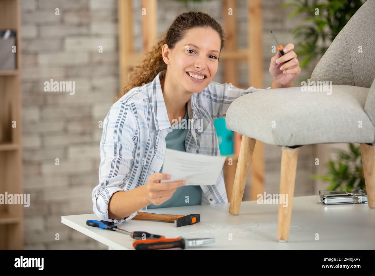 Worker screwdriver assembling chair hi-res stock photography and images ...