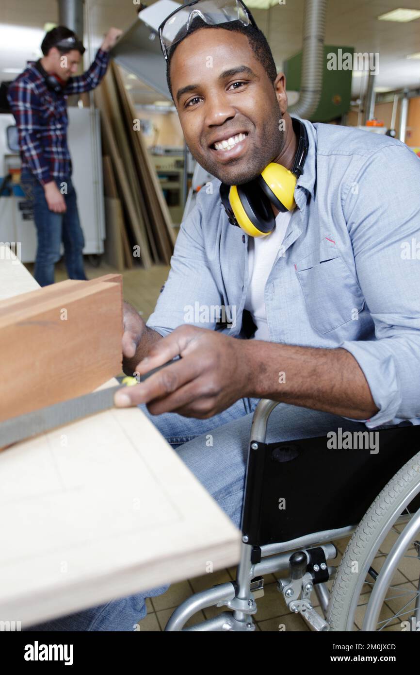 disabled worker in wheelchair as a carpenter Stock Photo - Alamy