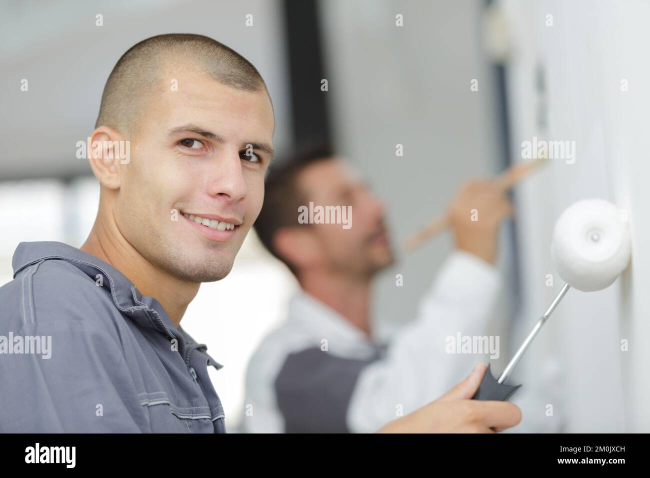 Painter in blue overalls painting hi-res stock photography and images ...
