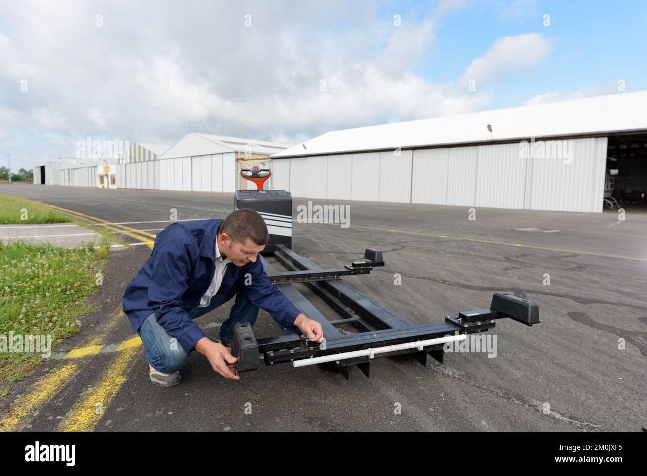 man checking machine for carrying luggage Stock Photo - Alamy