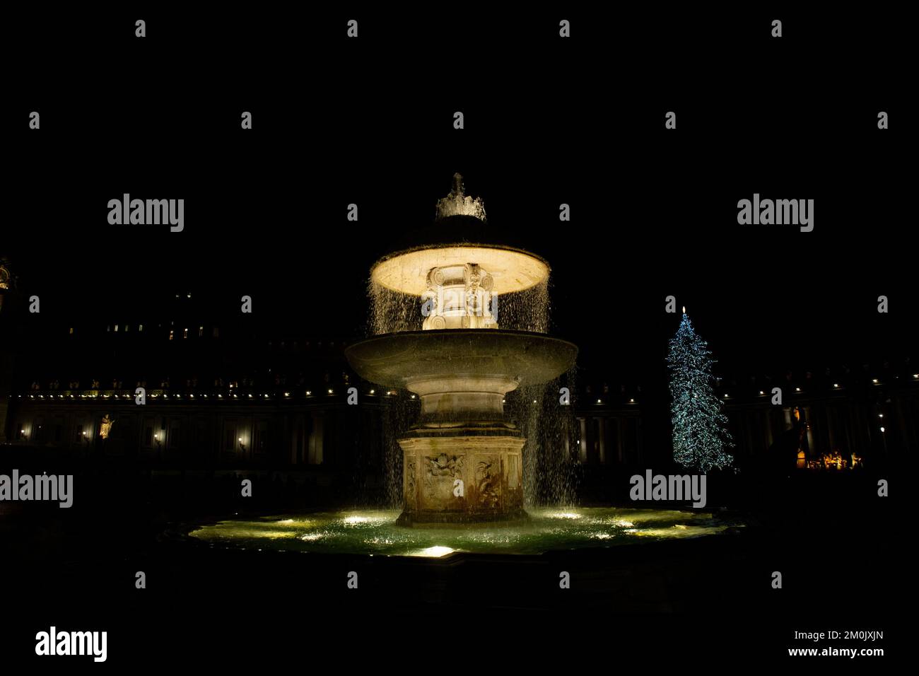 View of one of the fountains in St. Peter's Square with Christmas tree ...