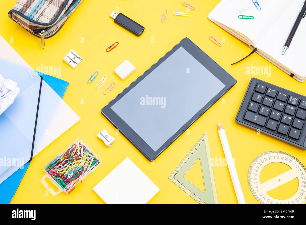 Black tablet with office supplies Stock Photo - Alamy