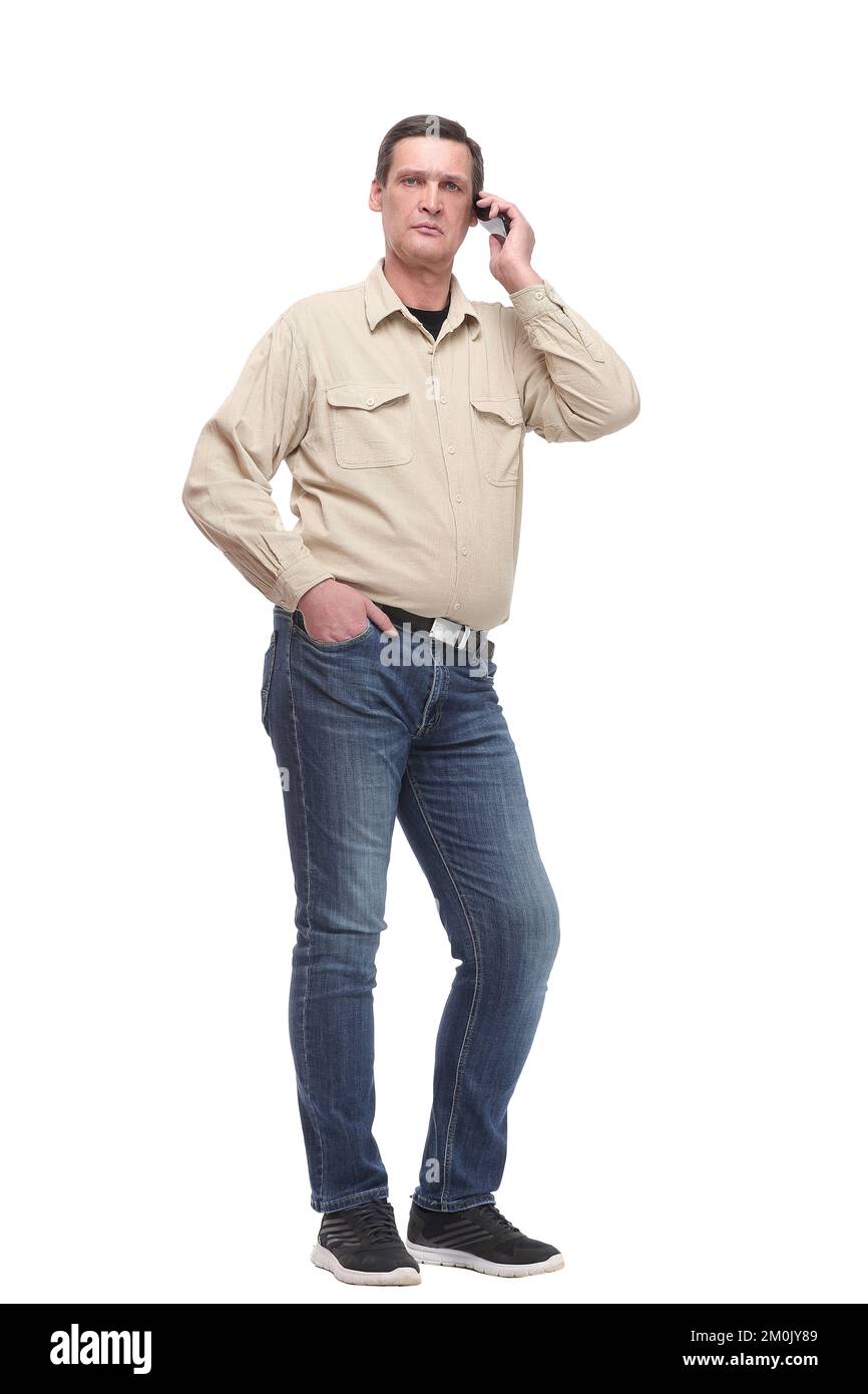 Serious young casual man standing with a hand in his pocket and ...