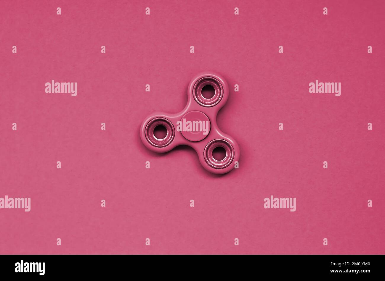 Green fidget spinner lies on texture background of fashion pastel green ...