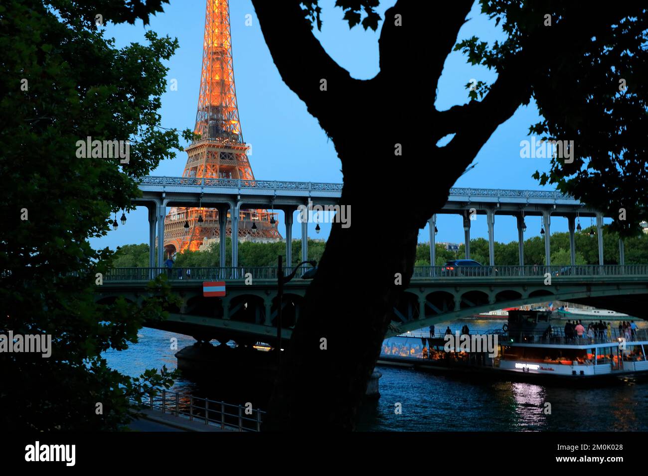 Eiffel Tower at twilight hour with Pont de Bir-Hakeim Bridge and a tour ...