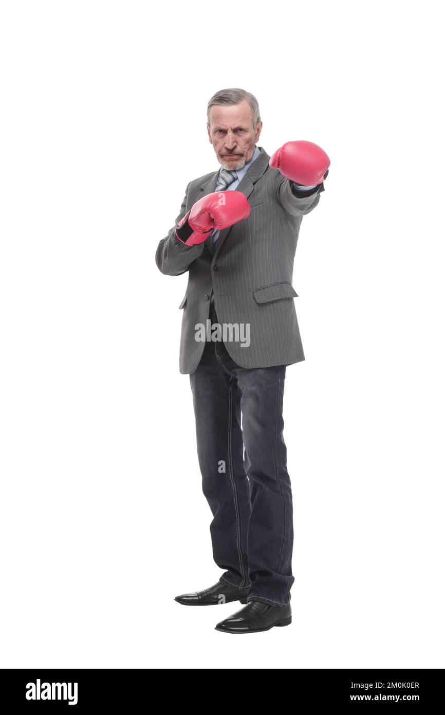 senior businessman wearing a gray suit with boxing gloves in a victory ...