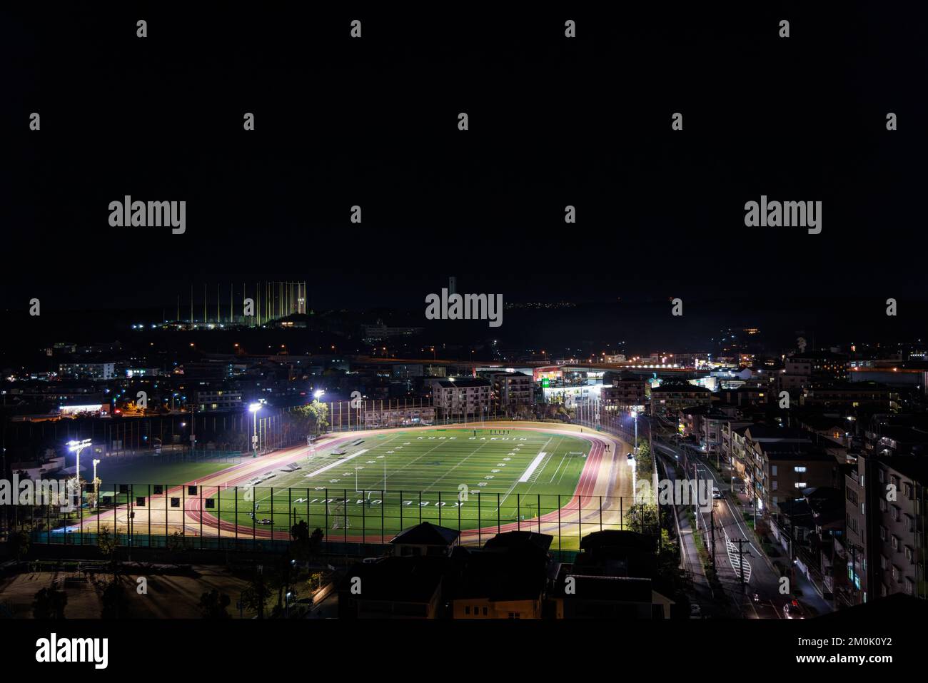 Bright lights shine on empty track and football field at night Stock ...