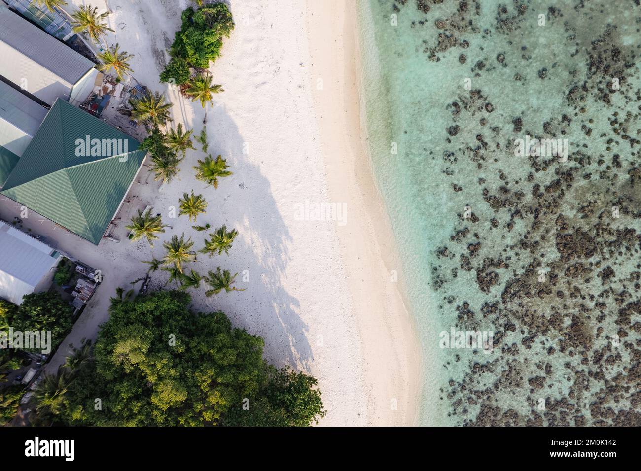 A beautiful bird's eye view of a white beach with bright turquoise ...