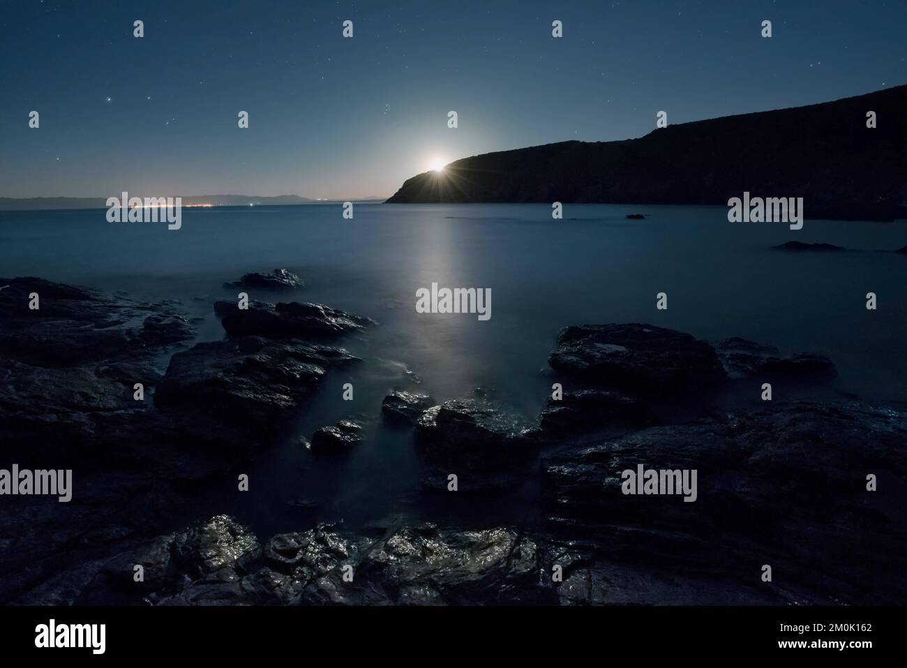 A gorgeous view of the sun peaking over hills at sunrise at a silent ...