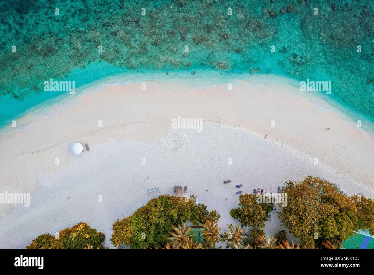 A beautiful bird's eye view of a white beach with bright turquoise ...