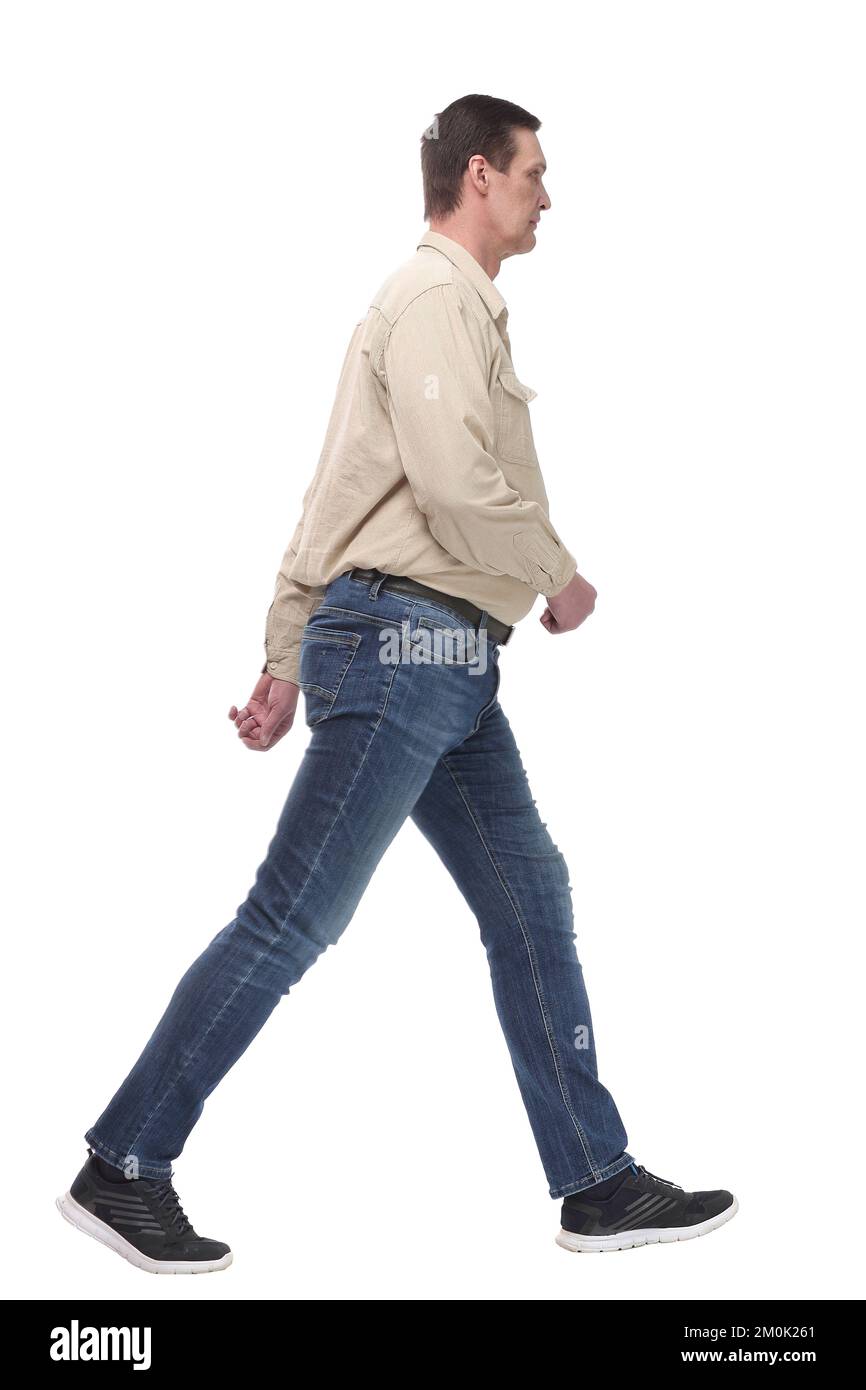 full length side view picture of a casual young man walking looking at ...