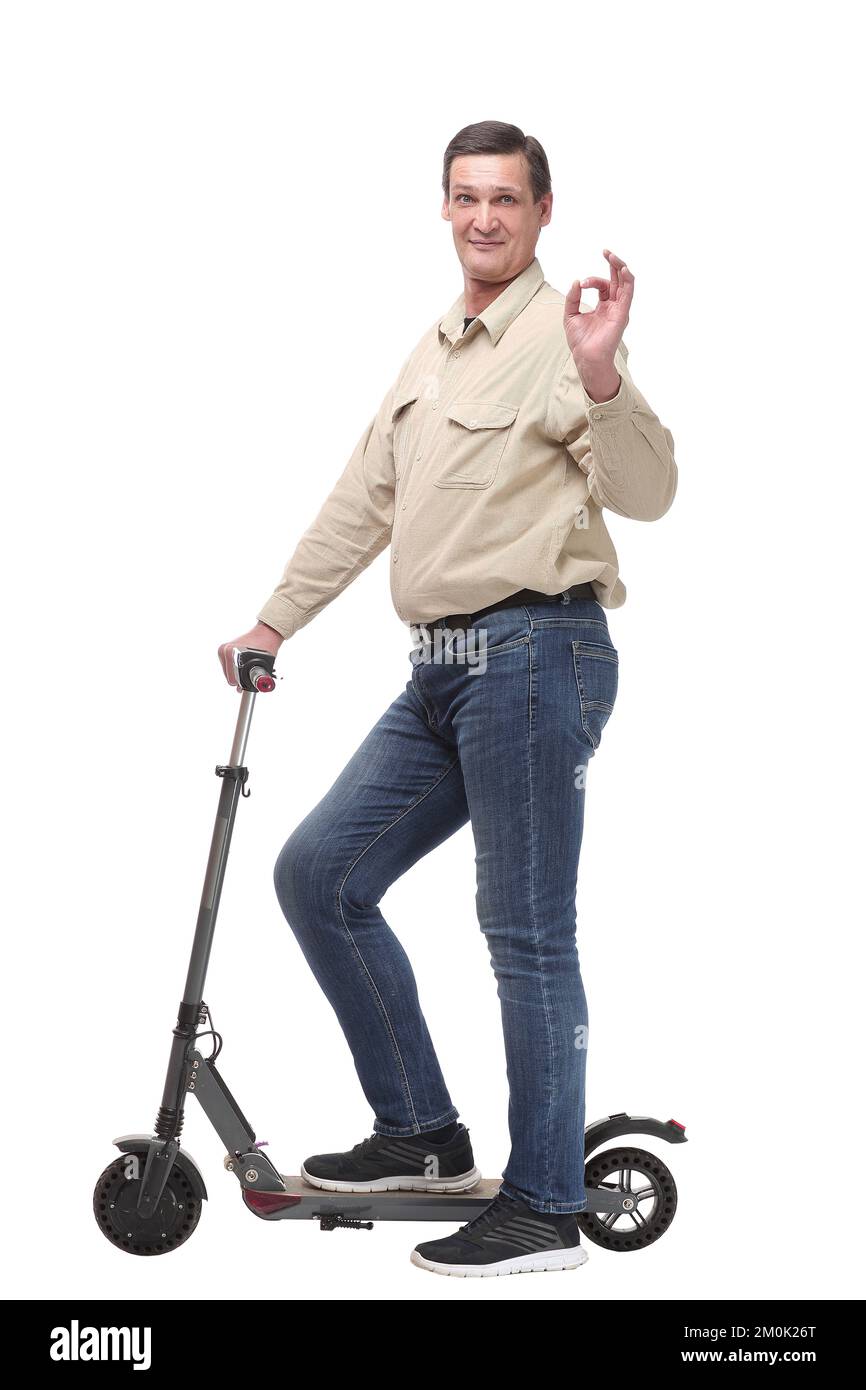 Side view of happy man rides a black kick scooter Stock Photo - Alamy