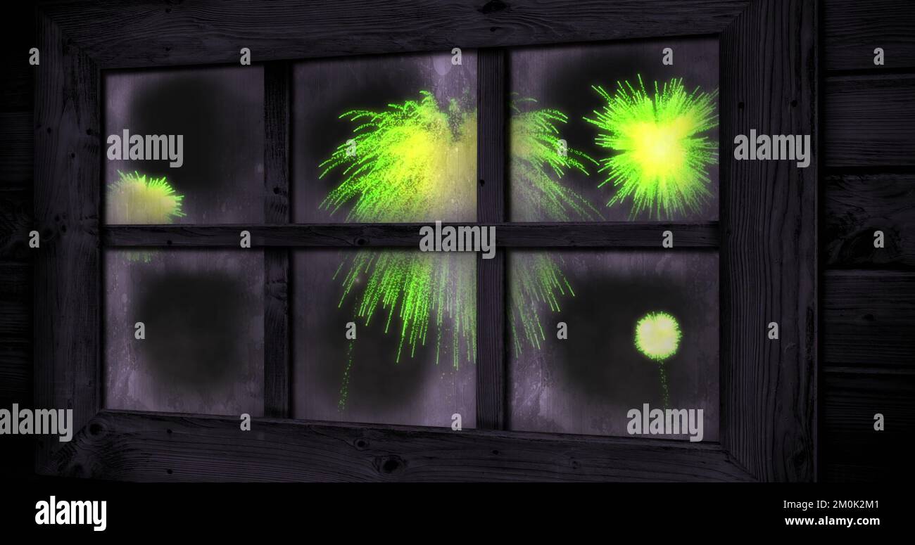 Image of window with green christmas and new year fireworks exploding ...
