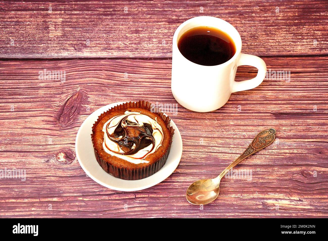 Biscuit tartlet with chocolate and cream on a wooden table, next to a ...