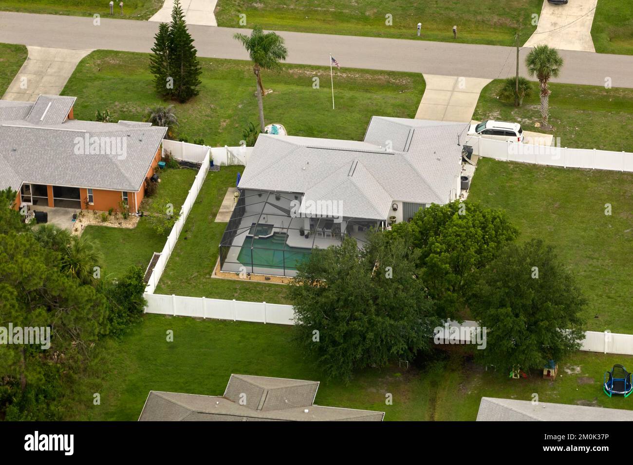 Aerial landscape view of suburban private houses between green palm ...