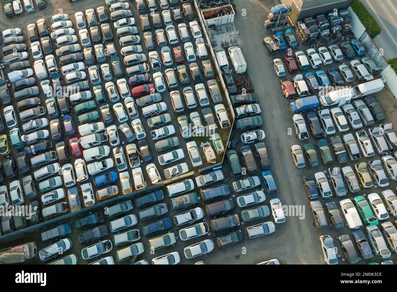 Aerial view of big parking lot of junkyard with rows of discarded ...