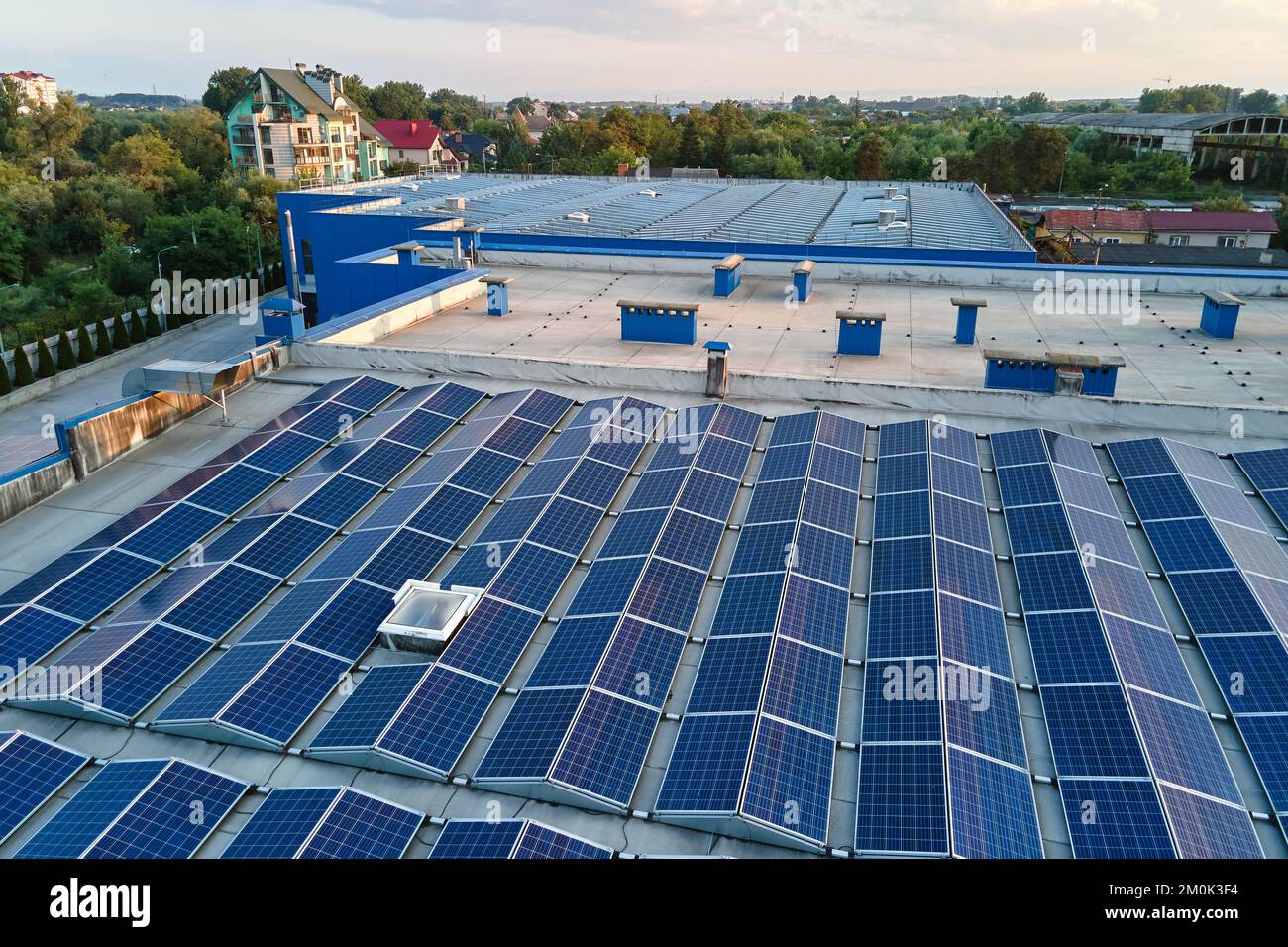 Aerial view of blue photovoltaic solar panels mounted on industrial ...