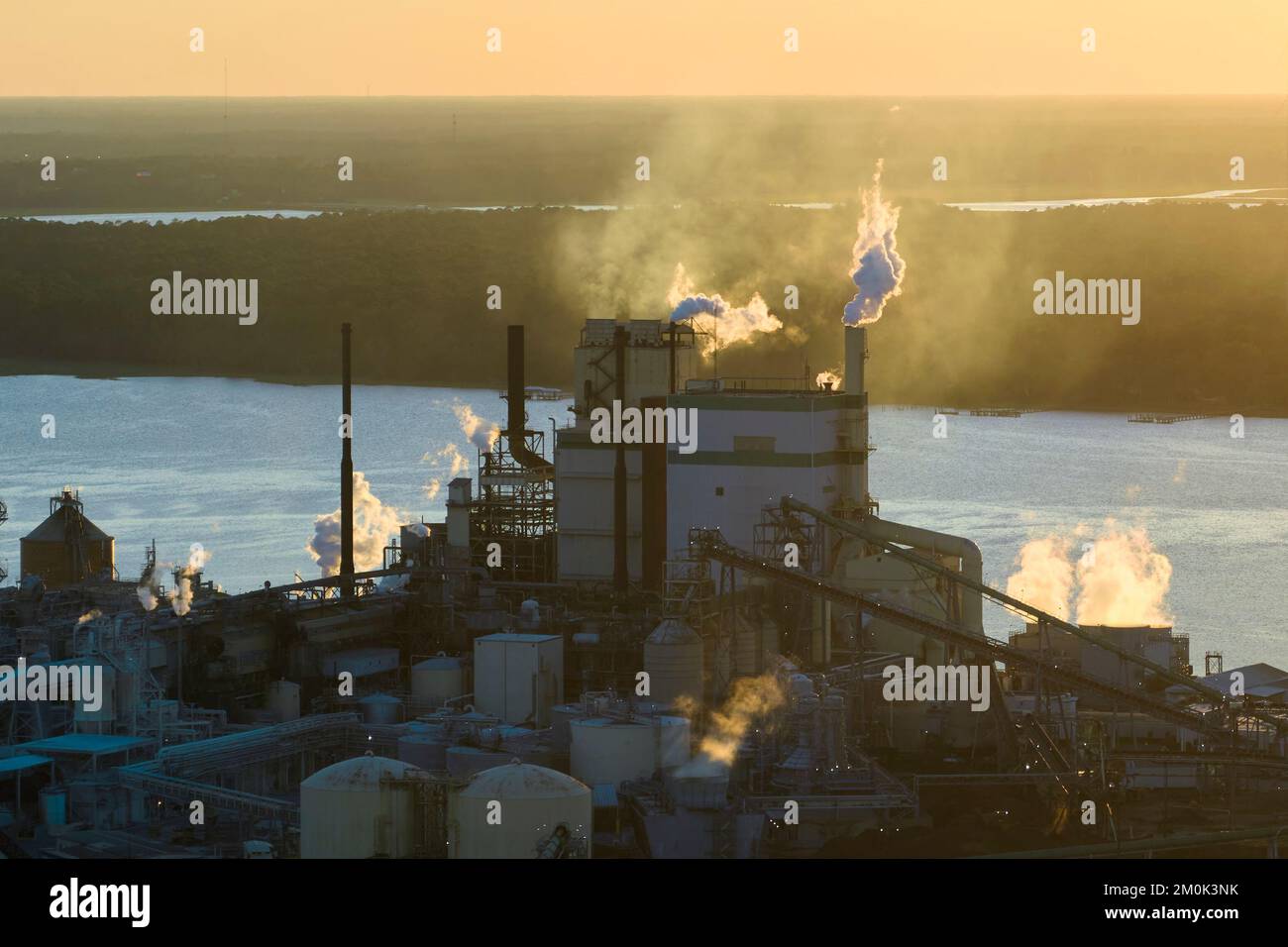 Aerial view of large factory with smokestack from production process ...