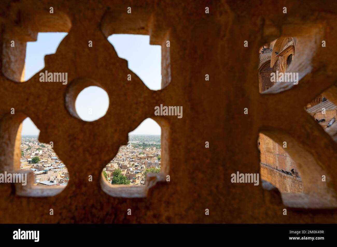 View of Jaisalmer city through sandstone made beautiful jharokha, stone ...