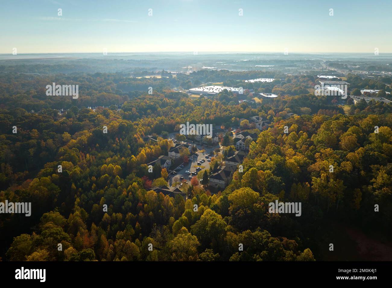 Aerial view of new apartment houses between yellow trees in South ...