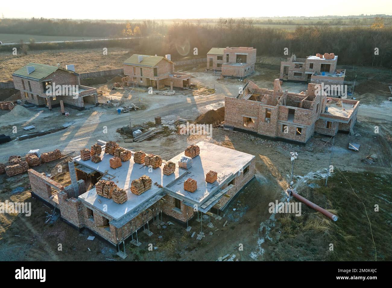 Aerial view of new homes with brick framework walls under construction ...