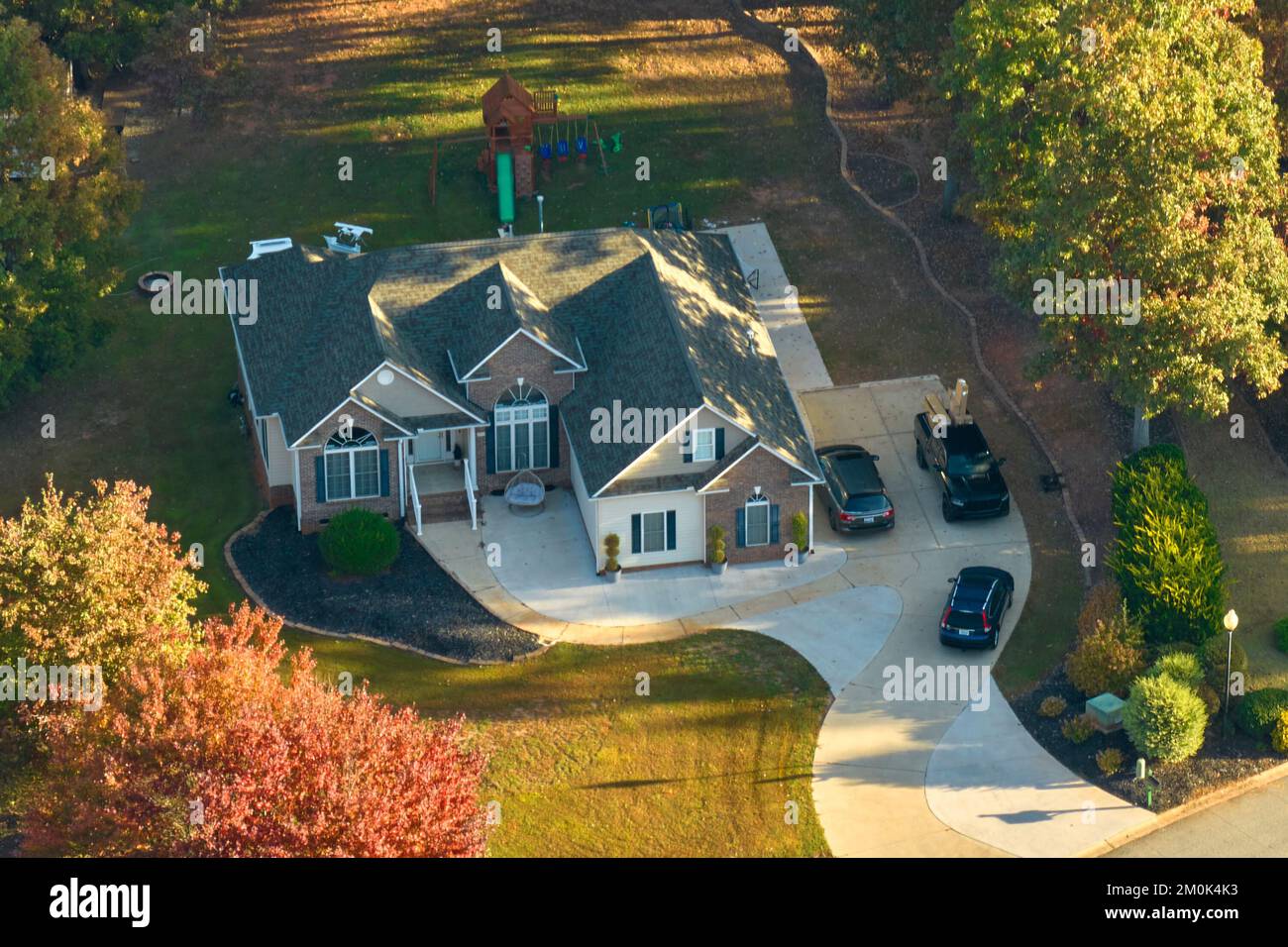Aerial view of new family house between yellow trees in South Carolina ...