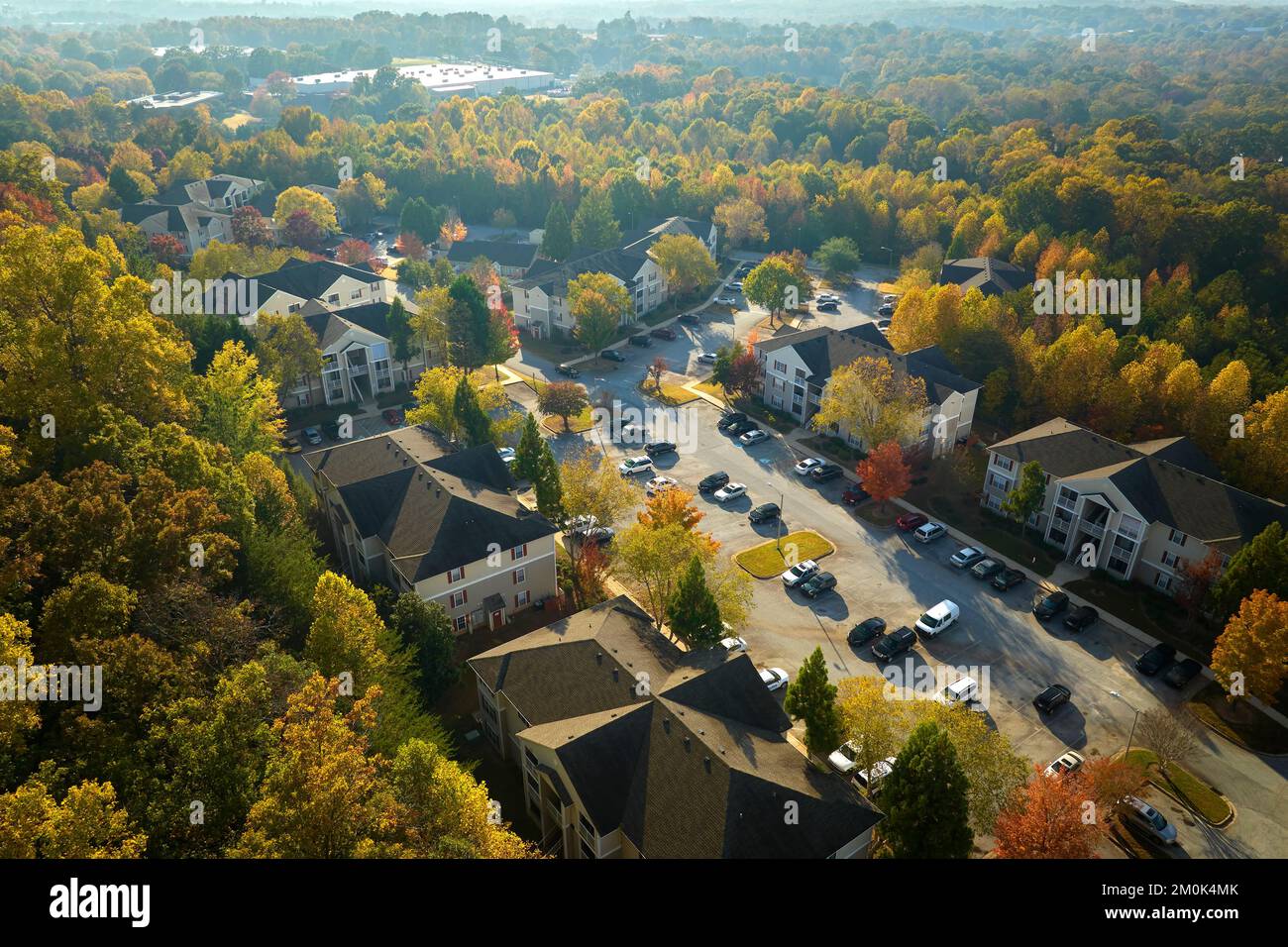 Aerial view of new apartment houses between yellow trees in South ...
