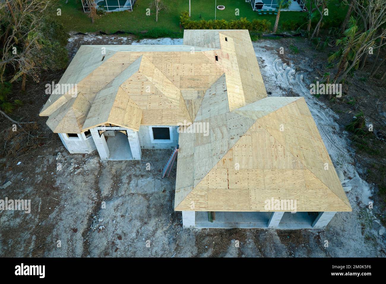 Aerial view of suburban private house with wooden roof frame under ...