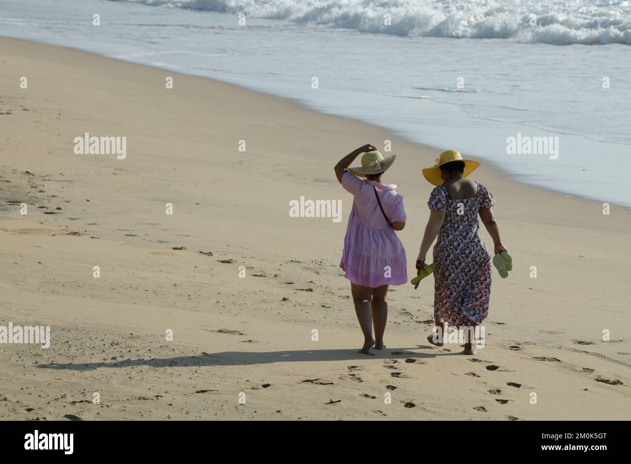 Friendship, two adult women enjoying walk on beach, summer vacation ...