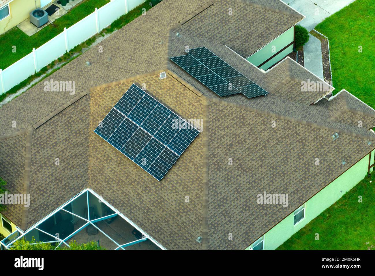 Aerial view of typical american building roof with blue solar photovoltaic panels for producing ...