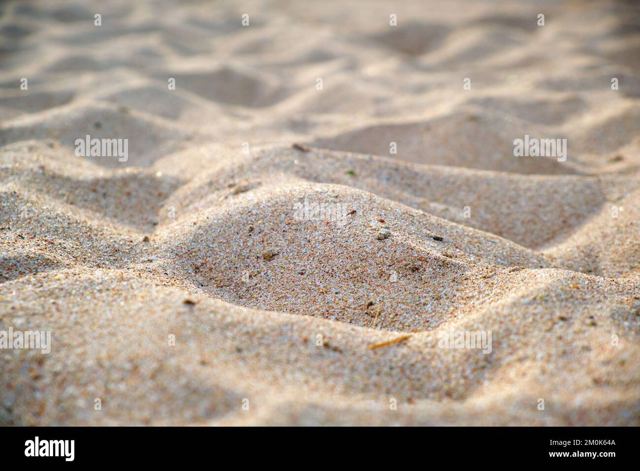 Close up of clean yellow sand surface covering seaside beach ...