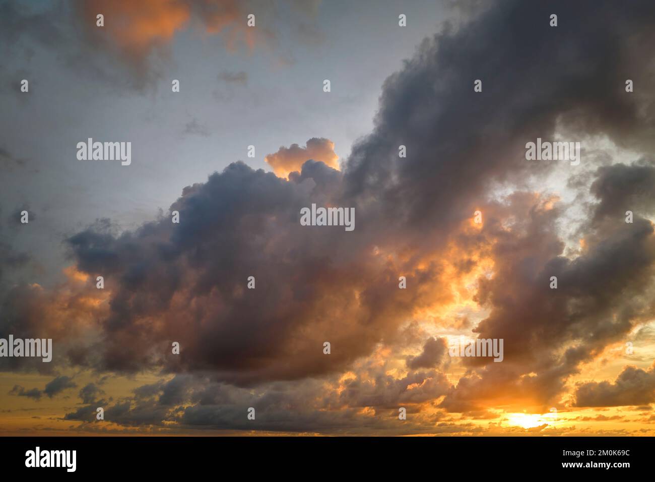 Colofrul clouds brightly illuninated by setting sun on evening sky ...