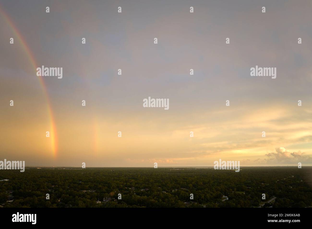 Colorful round rainbow against blue evening sky after heavy ...