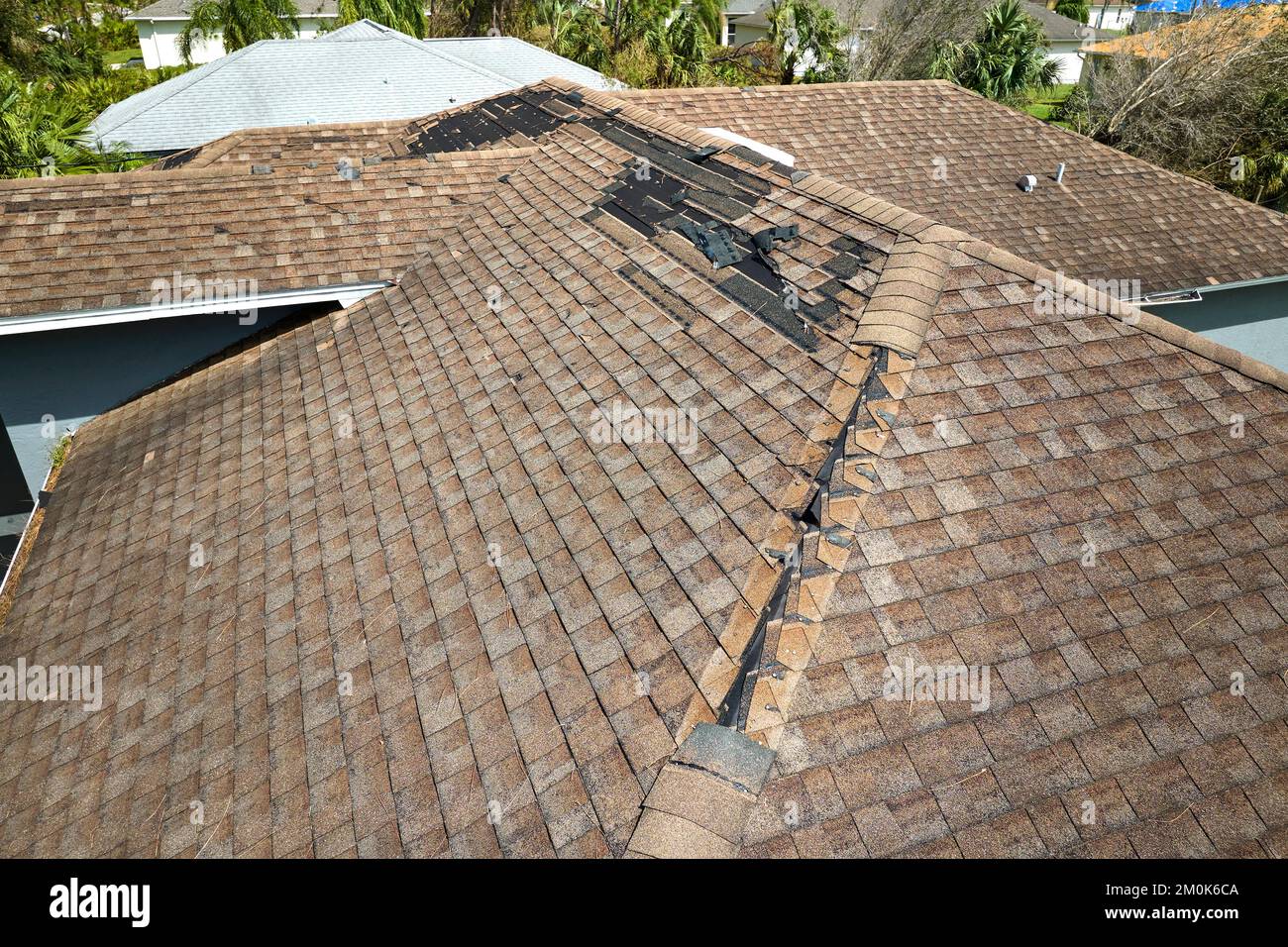 Damaged house roof with missing shingles after hurricane Ian in Florida ...