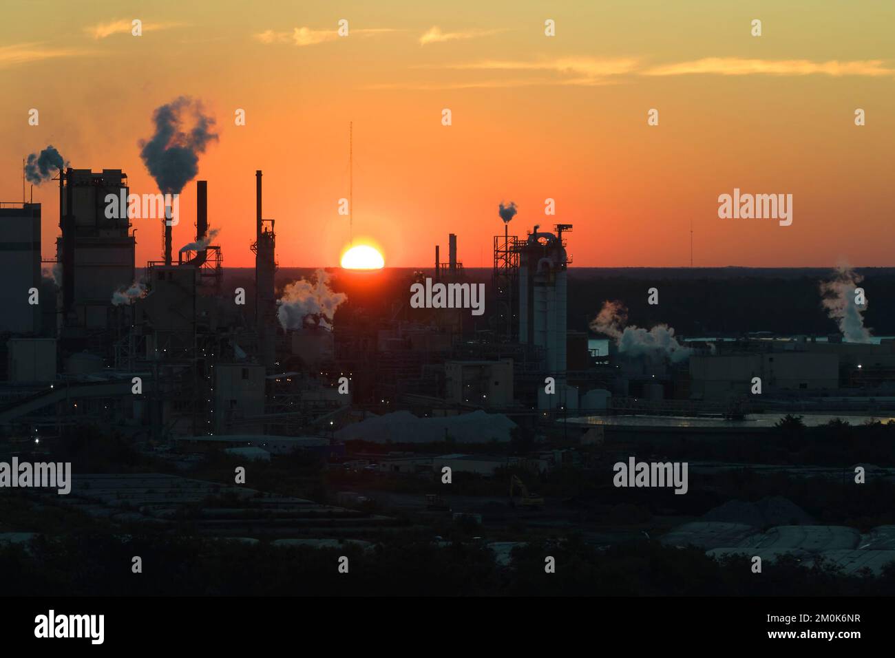 Huge factory with high chimneys polluting atmosphere with carbon ...