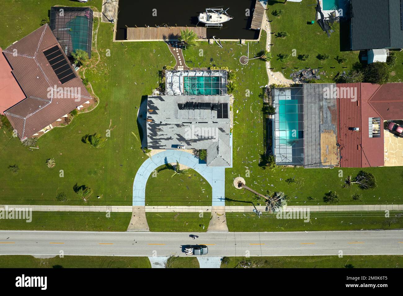 Hurricane Ian destroyed house roof in Florida residential area. Natural ...